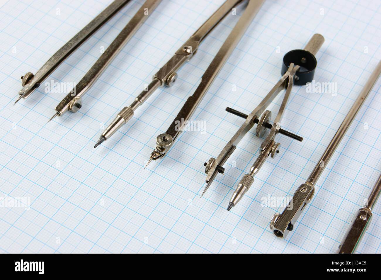 Old drawing tools on graph paper Stock Photo - Alamy