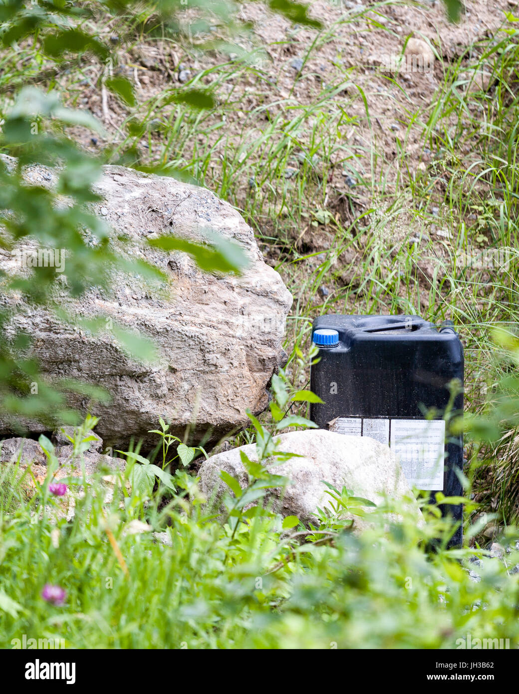 Industrial sized plastic container containing chemical waste litter ...