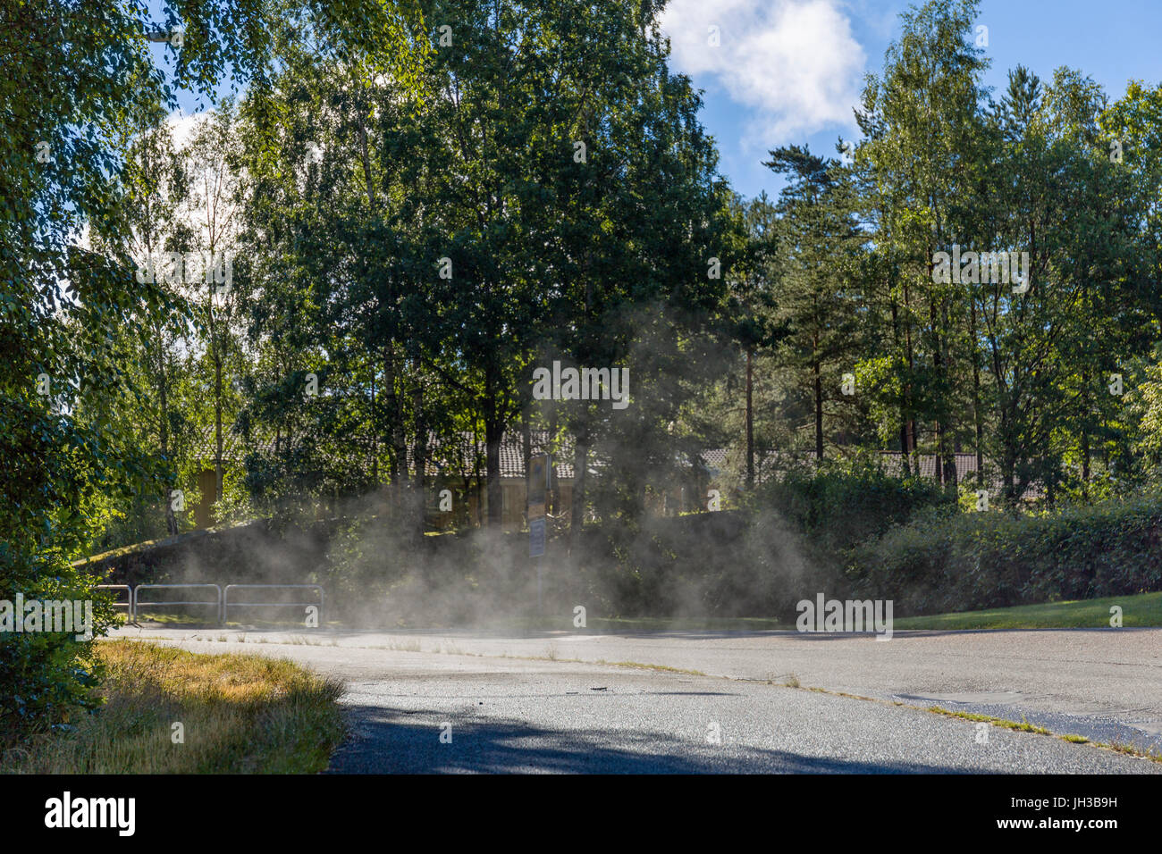 Steam rising from road surface due to sun heat Model Release: No ...