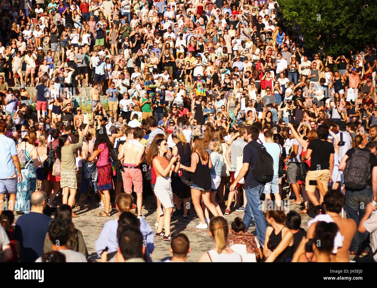 Young tourists (front, center) dance on the karaoke stage at Mauerpark ...
