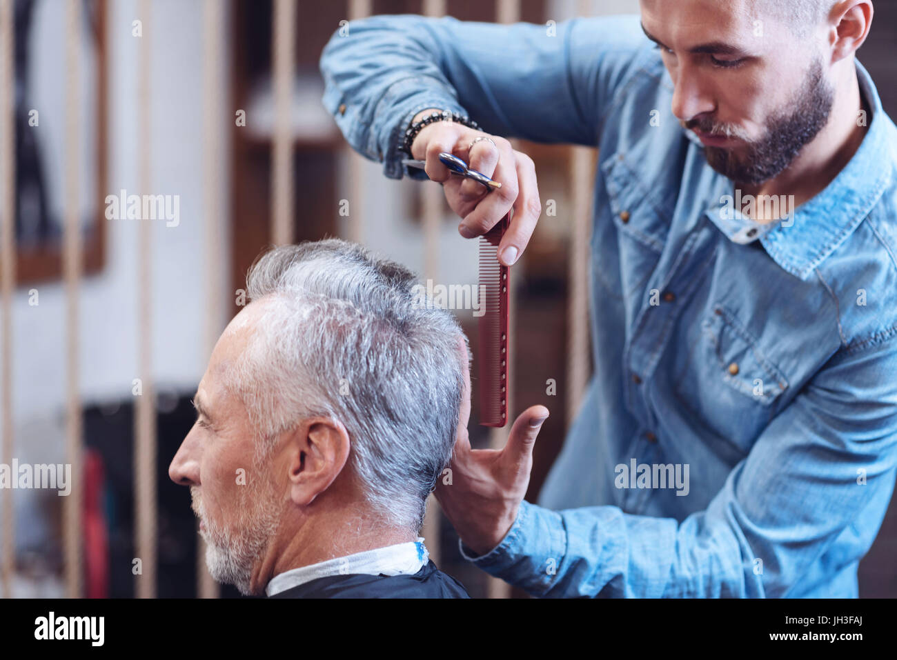 Professional hairdresser using scissors style hi-res stock photography ...
