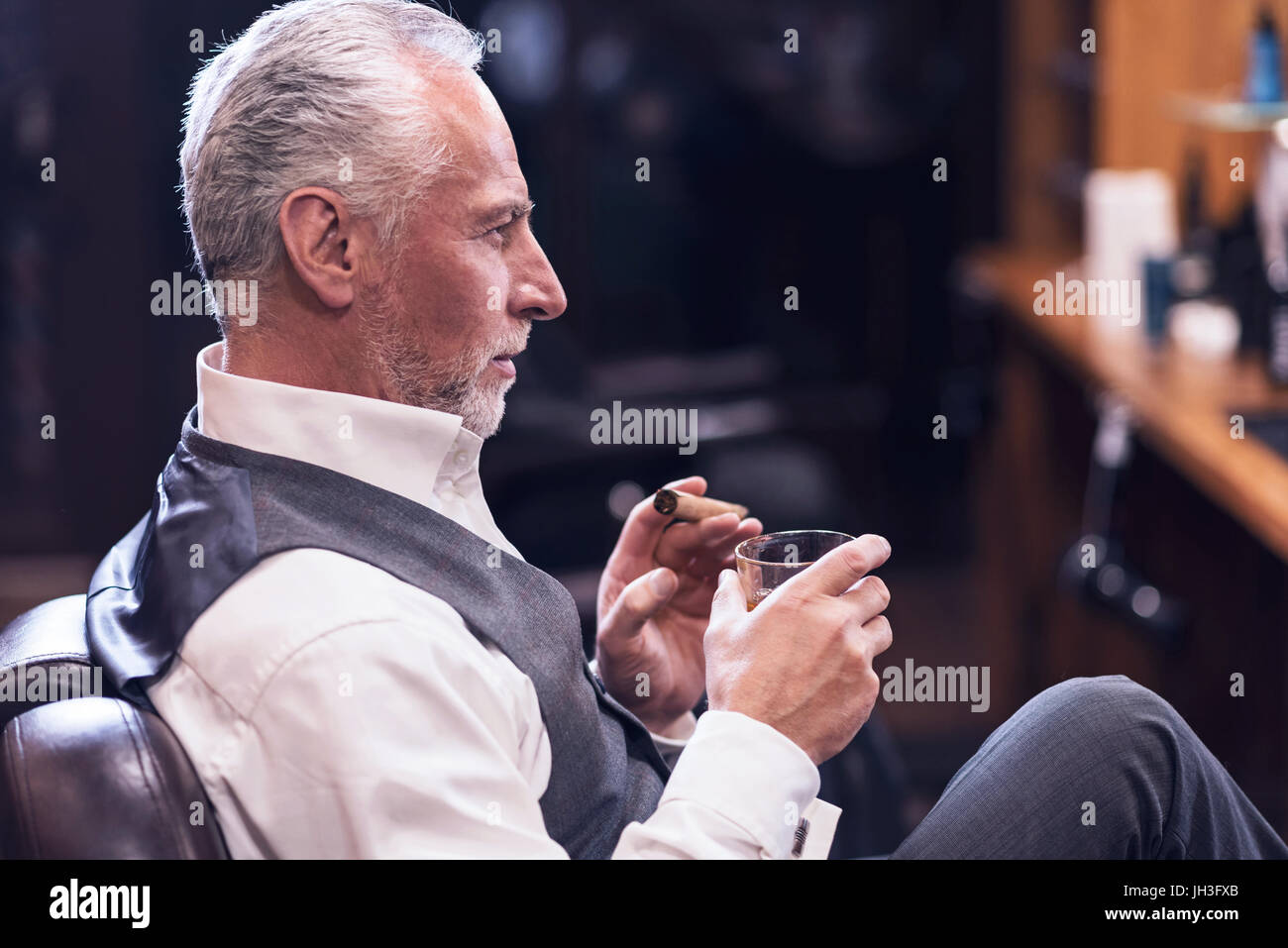Handsome stylish man drinking whisky Stock Photo - Alamy