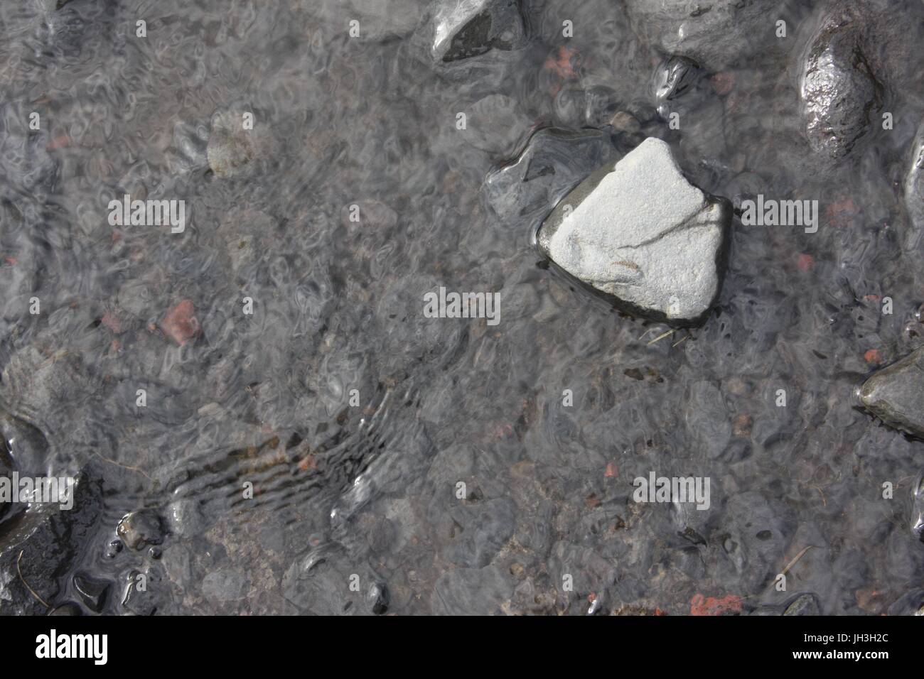 A rock in a river in Iceland Stock Photo - Alamy