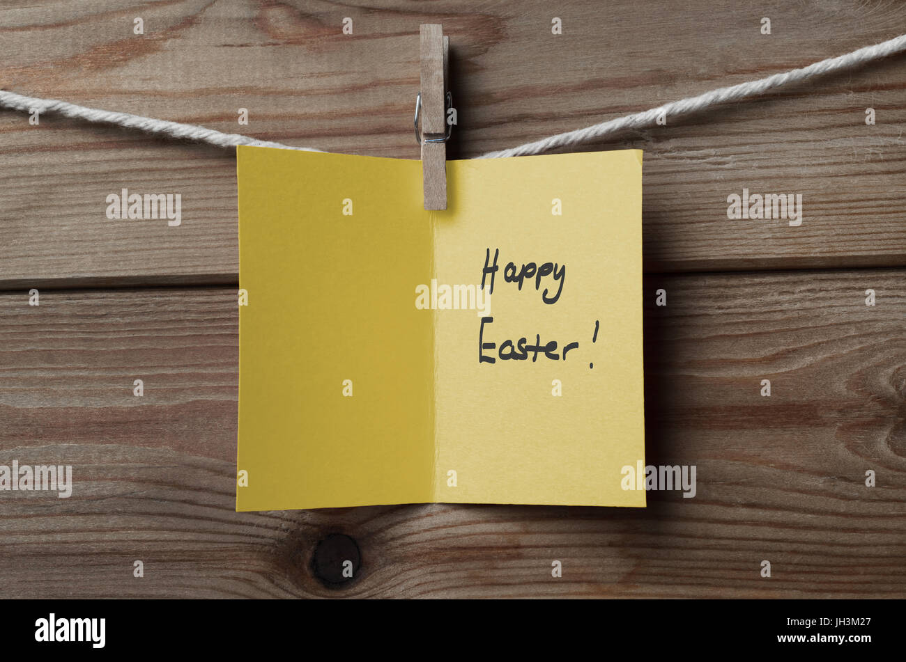 An opened, yellow greeting card, with 'Happy Easter' message written ...
