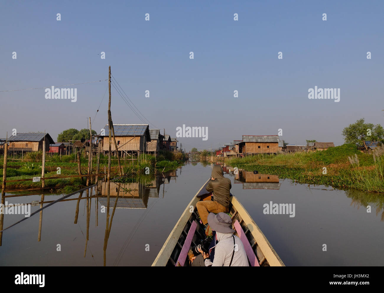 Inle, Myanmar - Feb 15, 2016. Tourists visit by wooden boat on Inle ...