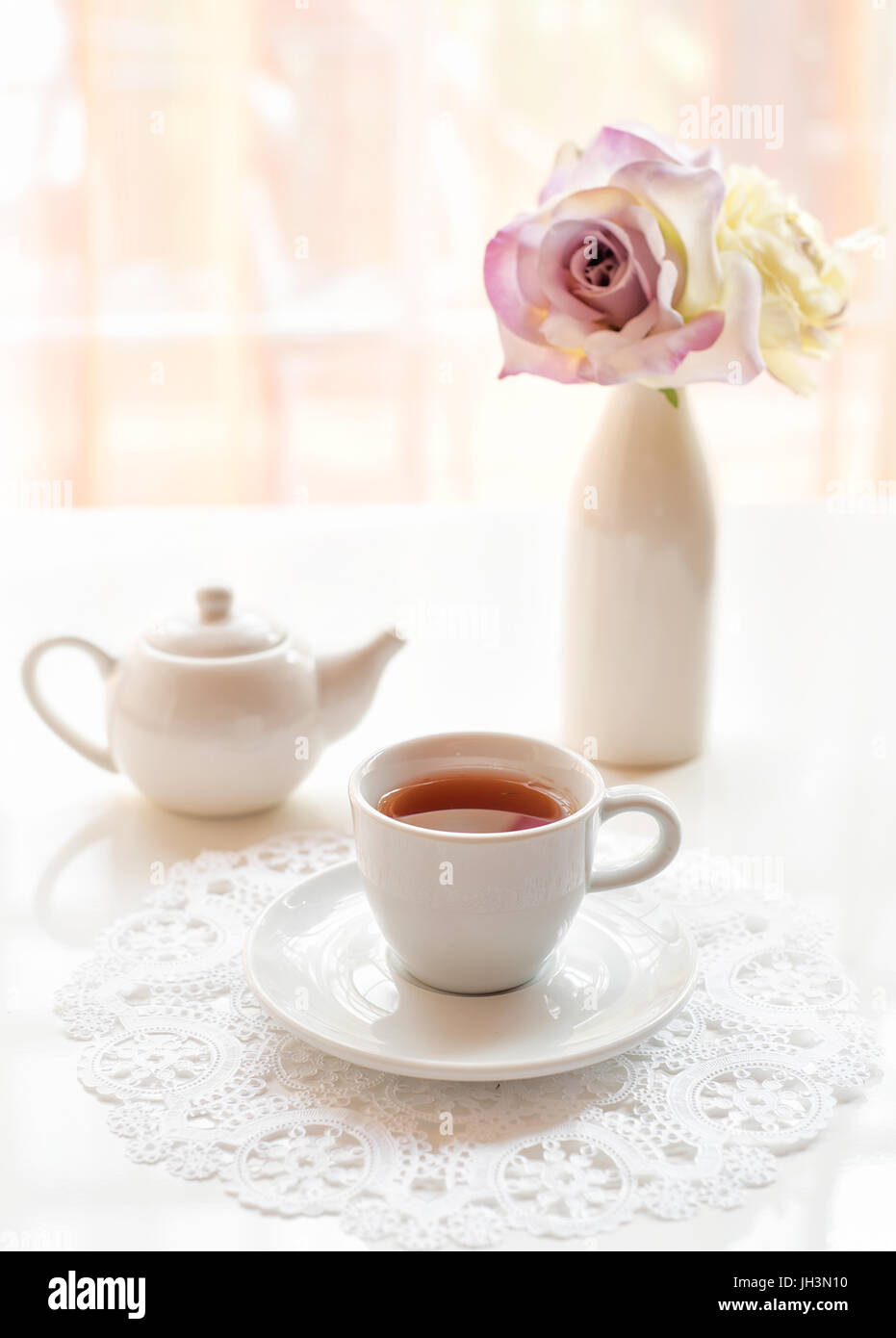Afternoon tea and roses on white table Stock Photo - Alamy