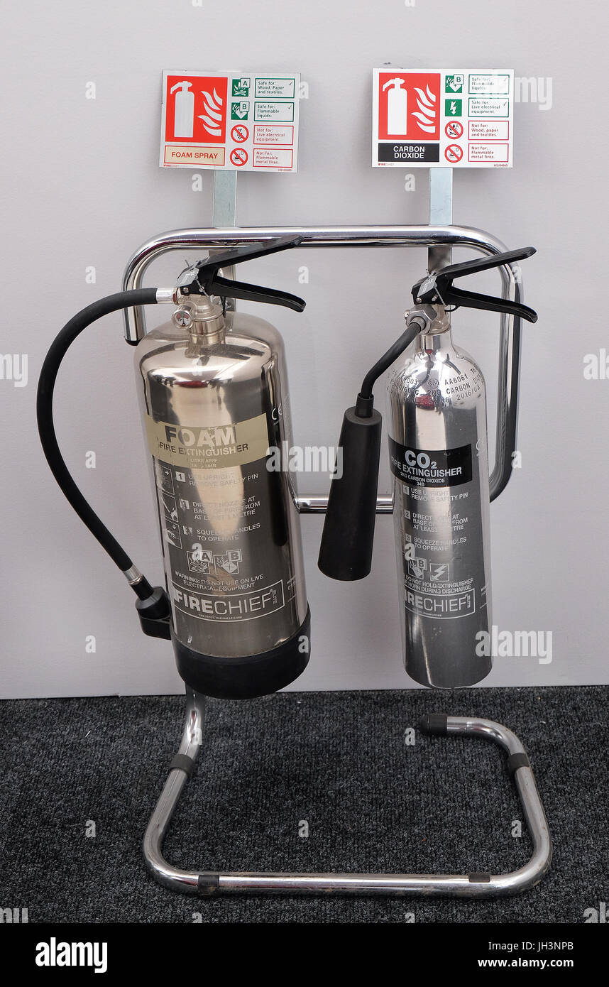 Hand fire extinguishers on mobile carry rack Stock Photo - Alamy