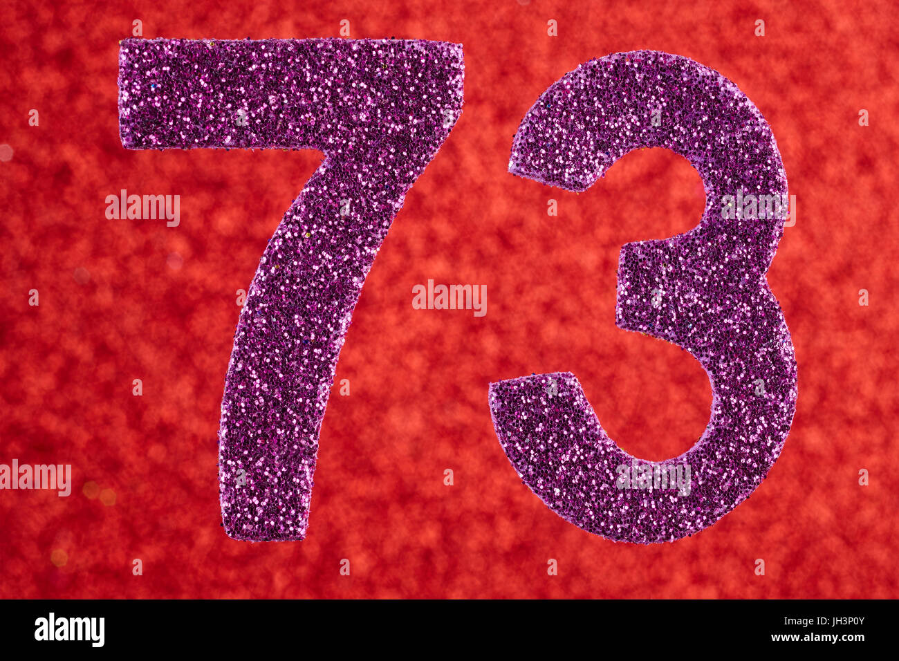 Number seventy-three purple color over a red background. Anniversary ...