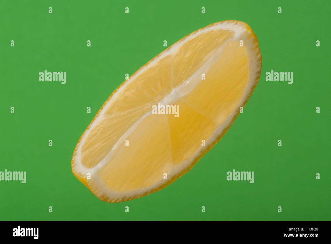 Lemon part on green background. Studio shoot Stock Photo - Alamy
