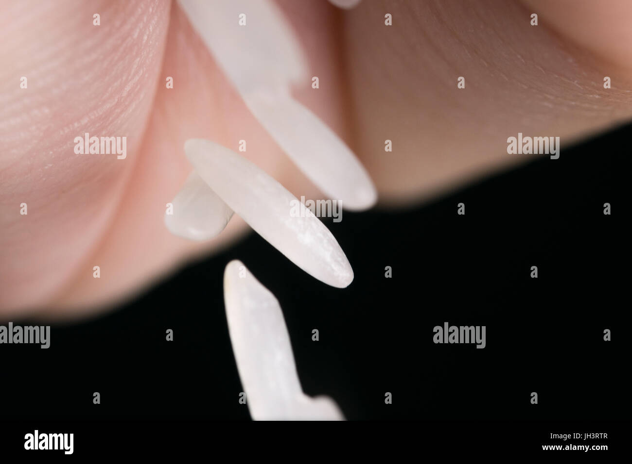 Rice on hand Stock Photo - Alamy