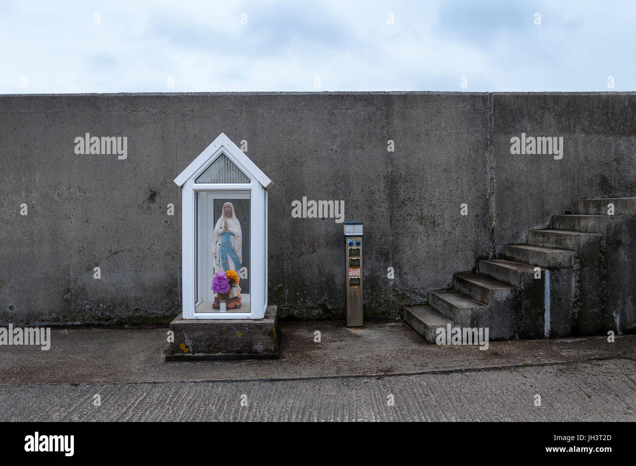 Votive statue of Mother Mary on pier at Teelin harbour, County Donegal ...
