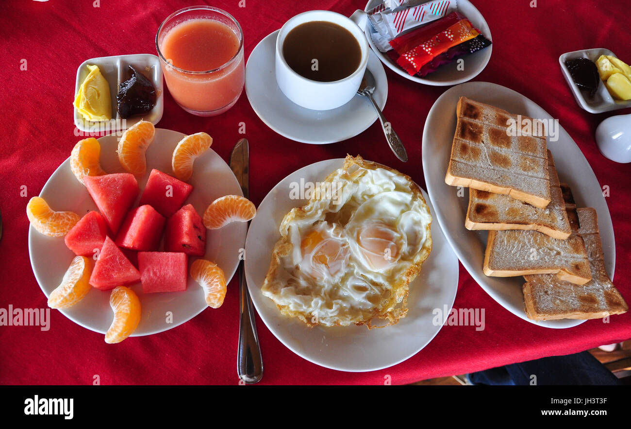 Western breakfast with coffee, bread, eggs and fruits. Close up Stock ...