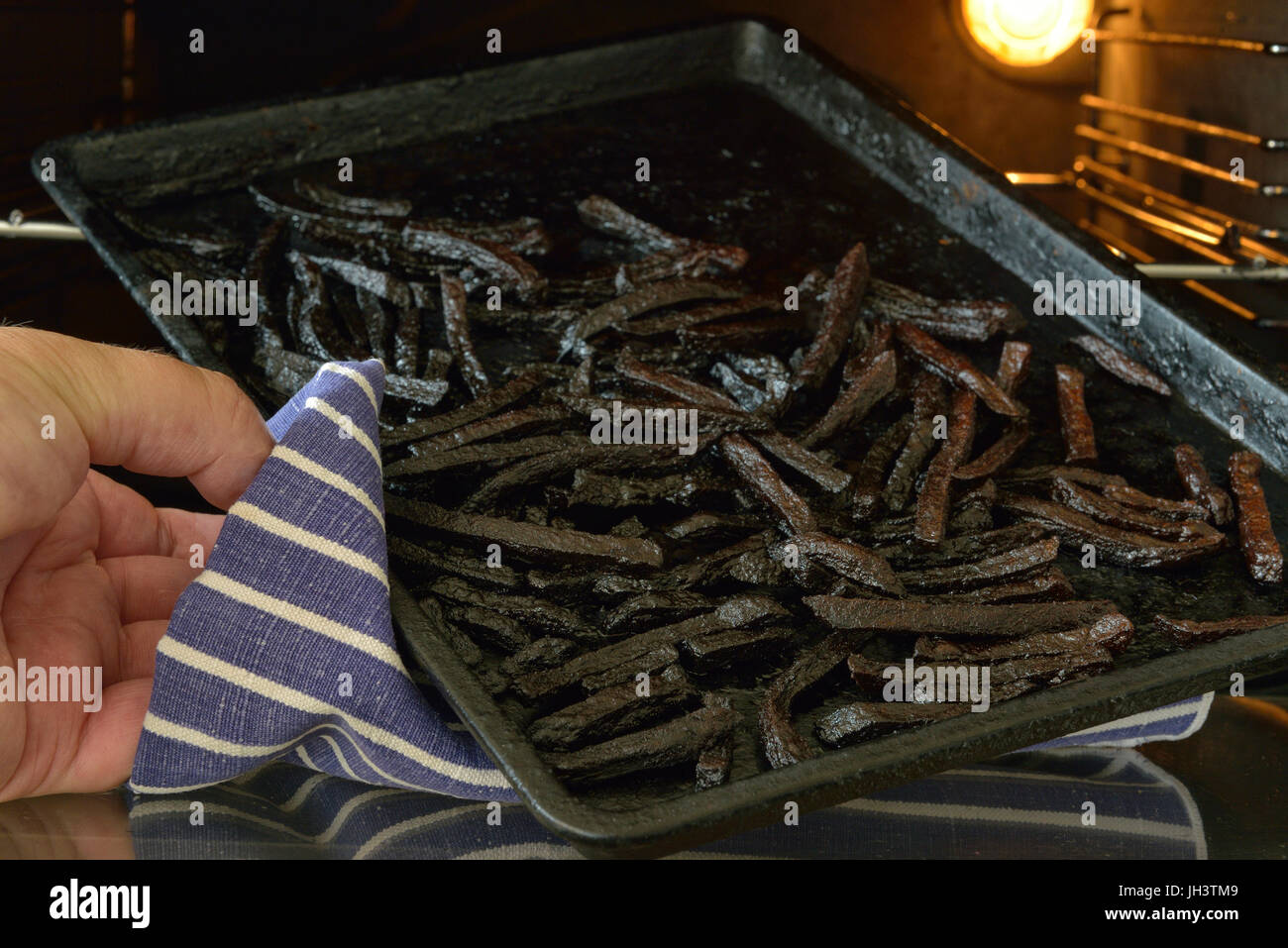 Burnt oven cooked french fries Stock Photo - Alamy