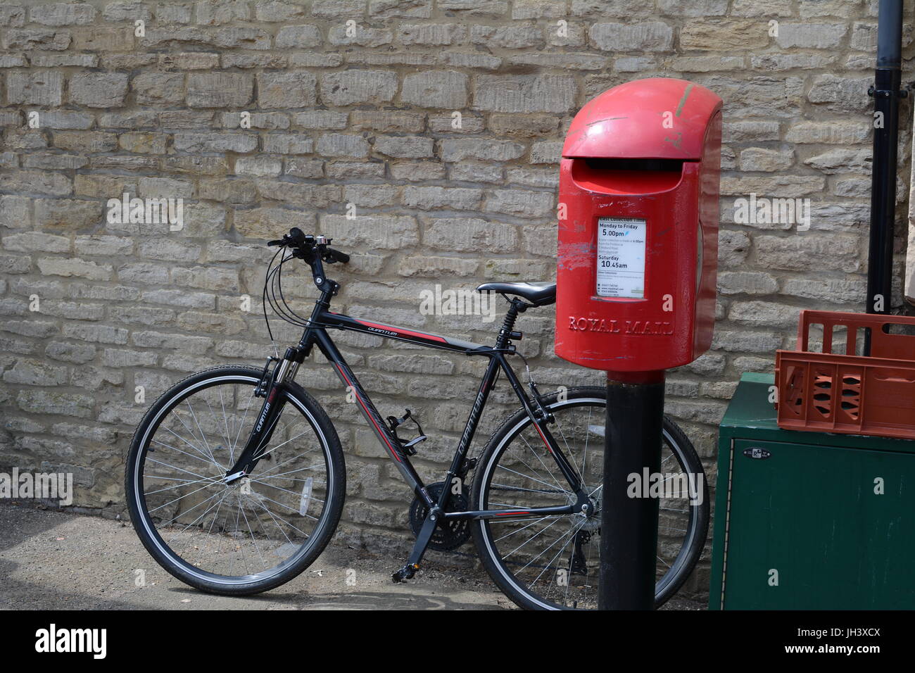 Bike near post box old style wall stone red box mail post office ...