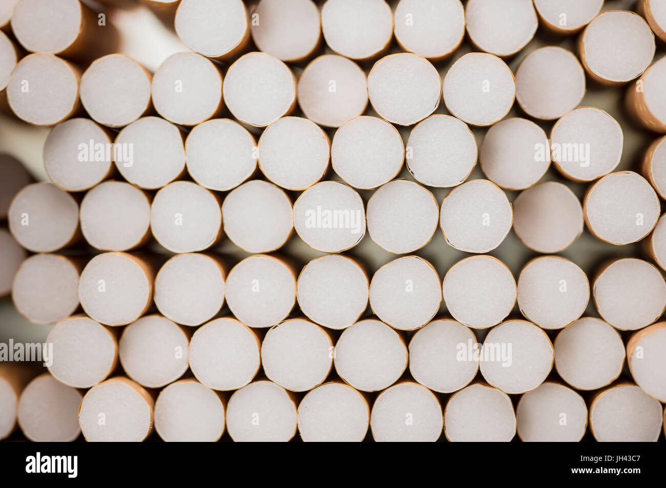 Close up shot of a pile of cigarettes background Stock Photo - Alamy