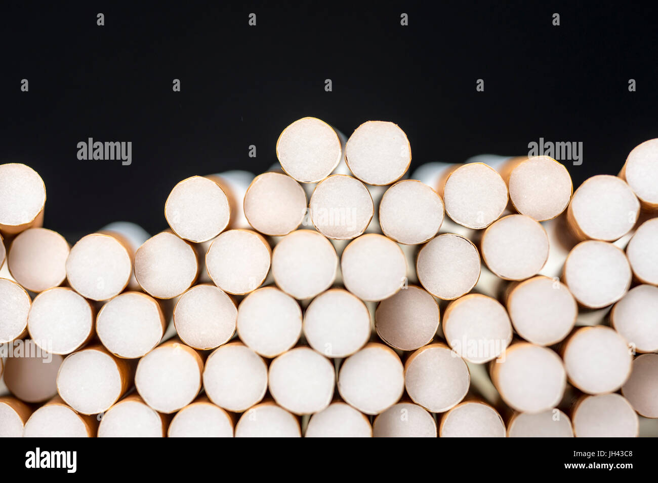 Close up shot of a pile of cigarettes background Stock Photo - Alamy