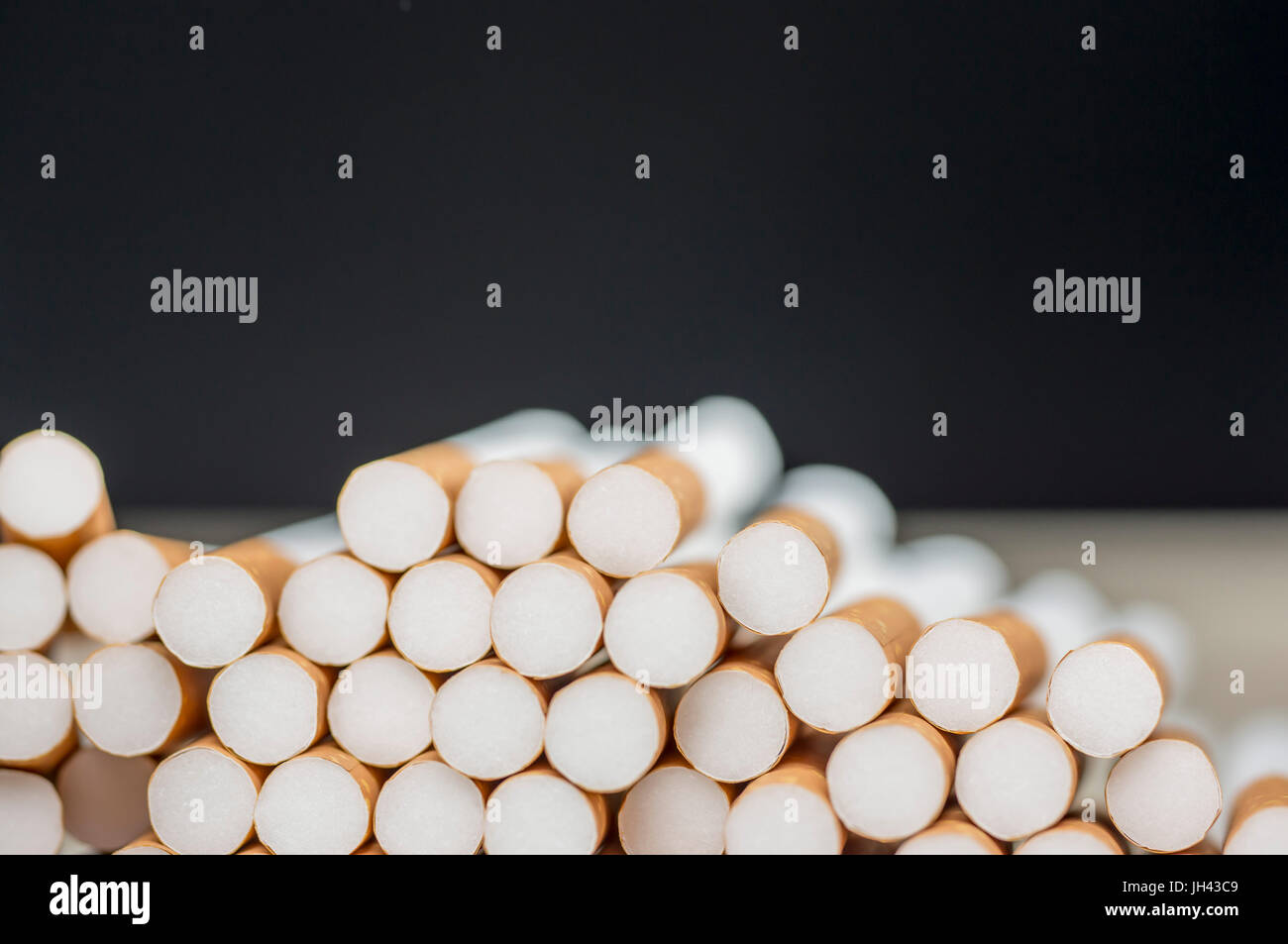 Close up shot of a pile of cigarettes background Stock Photo - Alamy