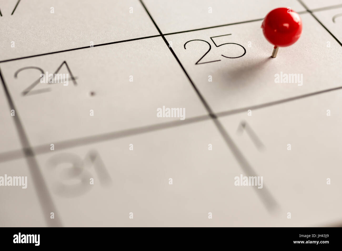 Close up shot of a red pin on the 25th day on calendar Stock Photo - Alamy