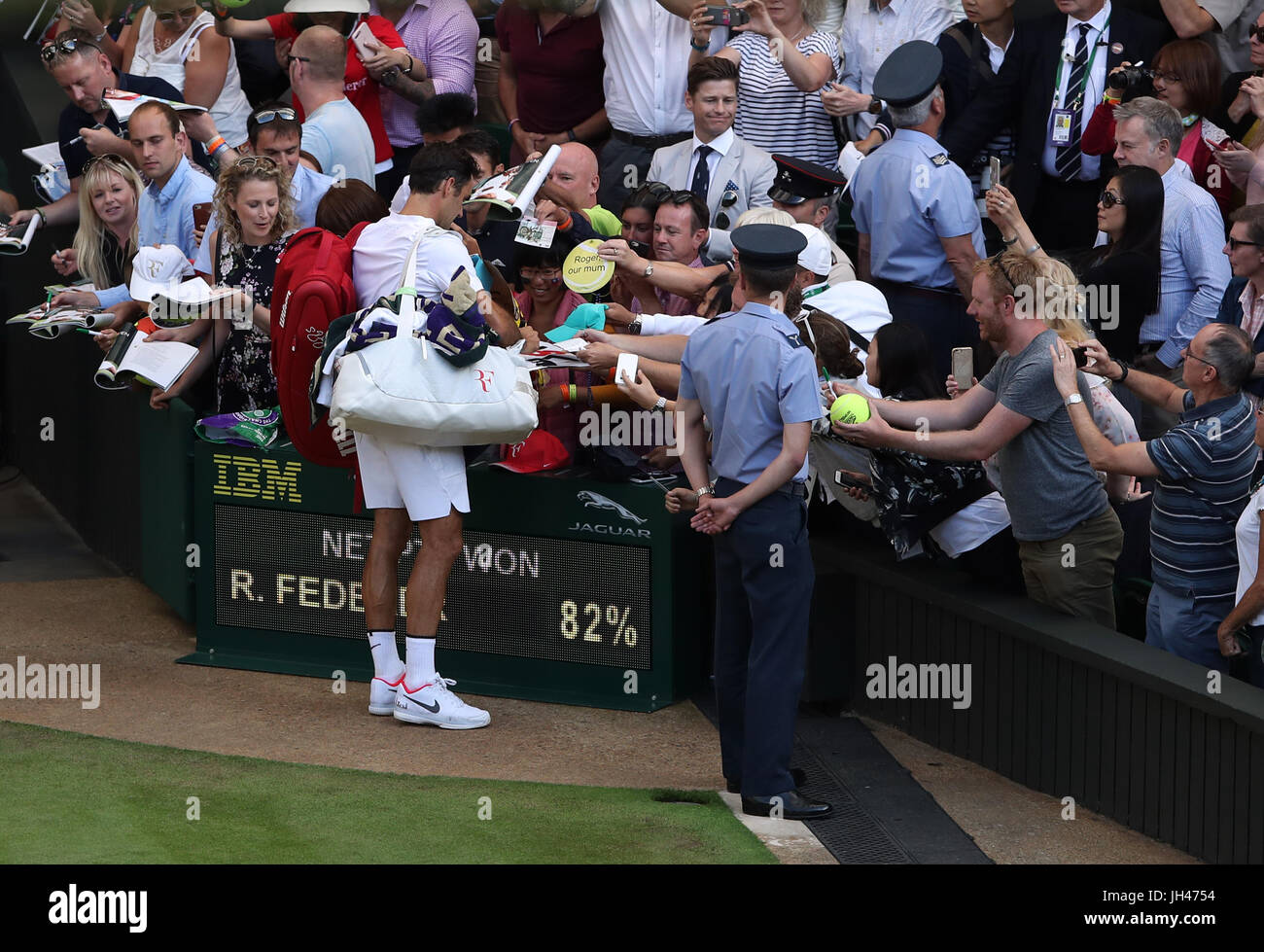 Roger Federer signs autographs for spectators following his victory ...