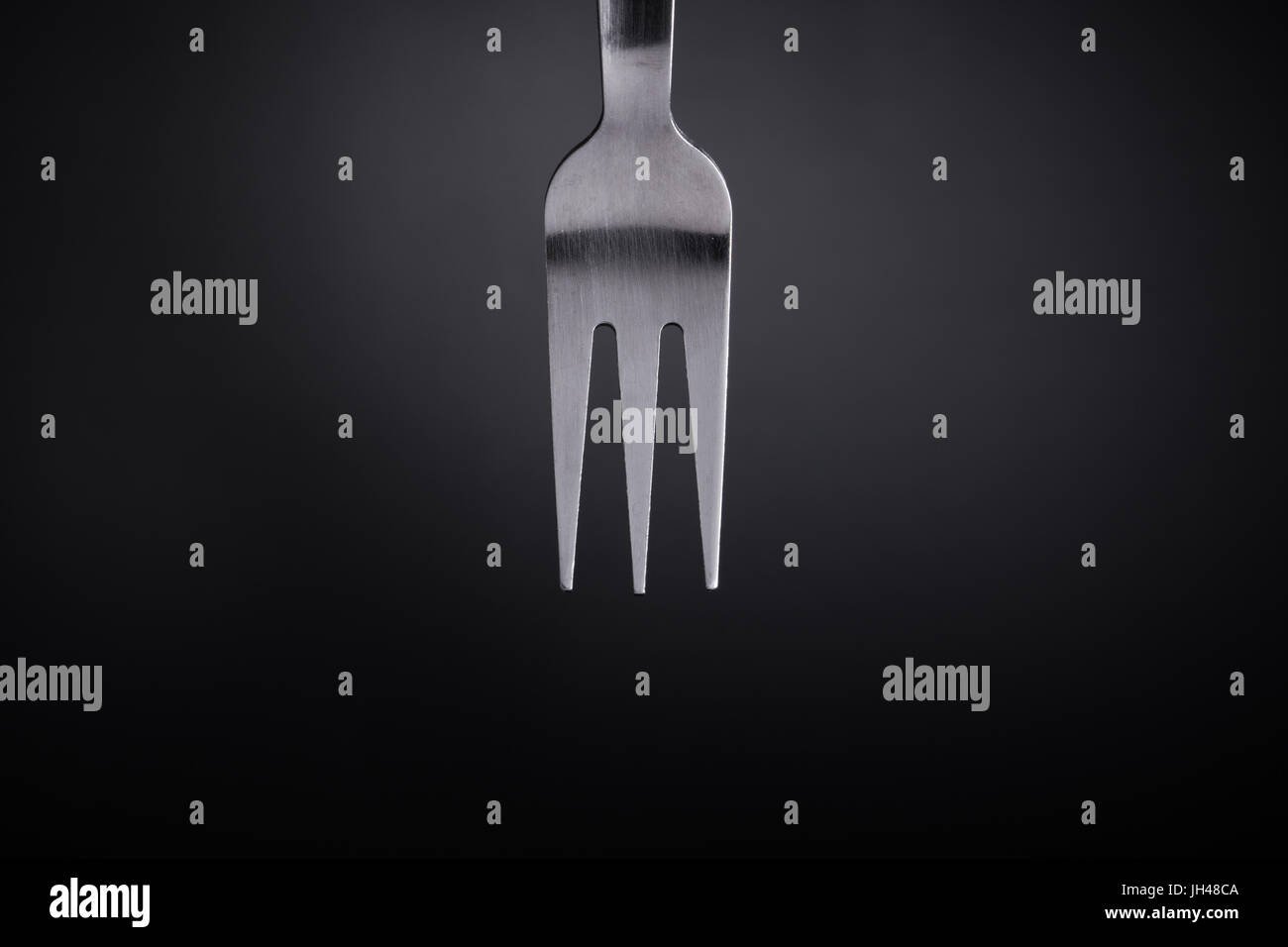 Fork in black background Stock Photo - Alamy