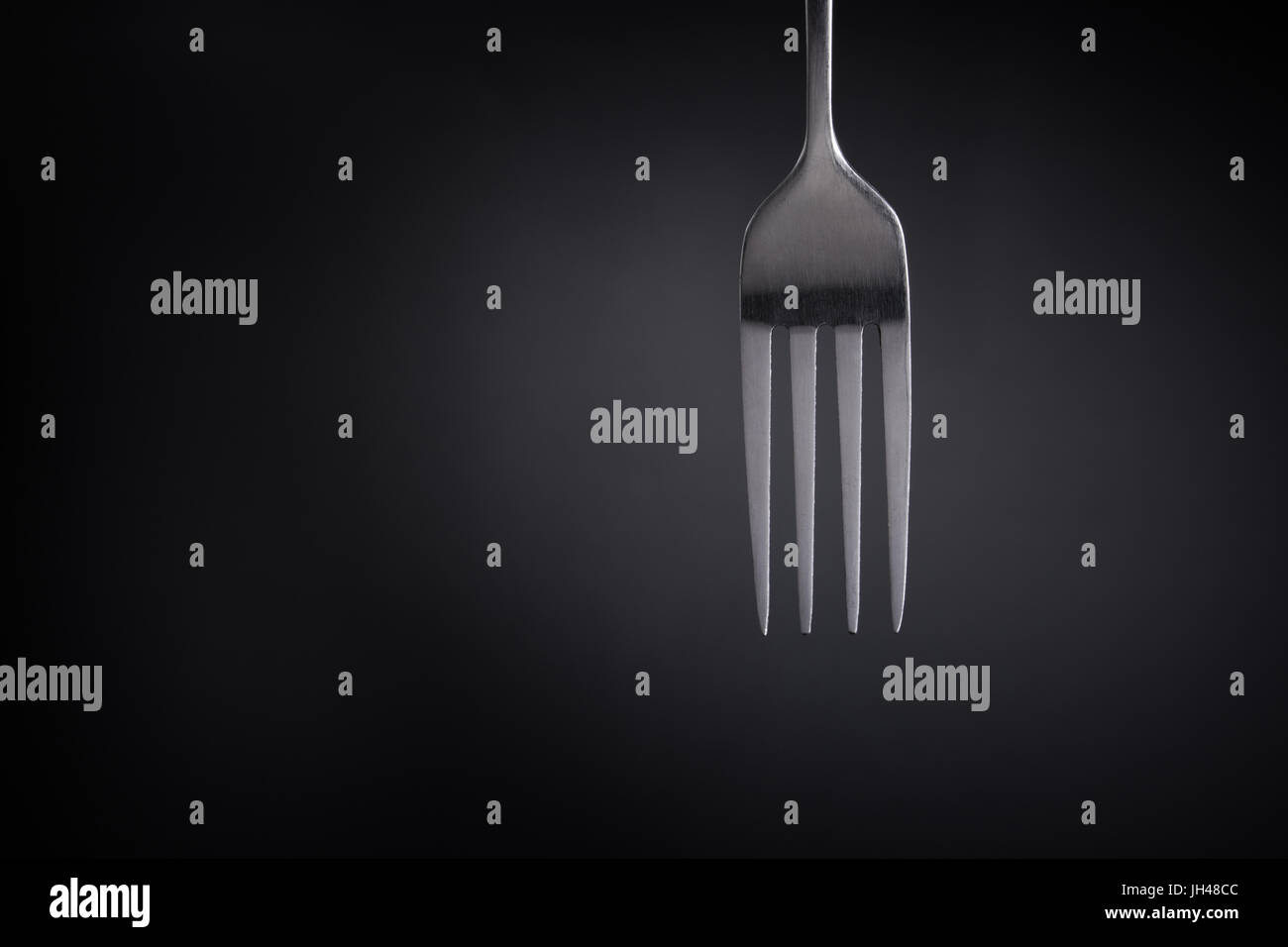Fork in black background Stock Photo - Alamy