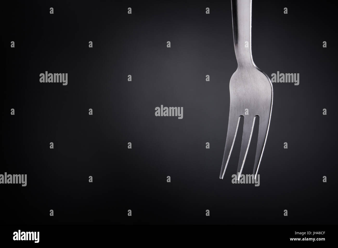Fork in black background Stock Photo - Alamy