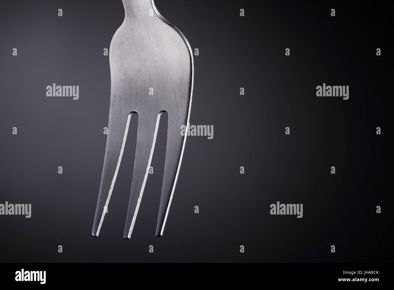Fork in black background Stock Photo - Alamy