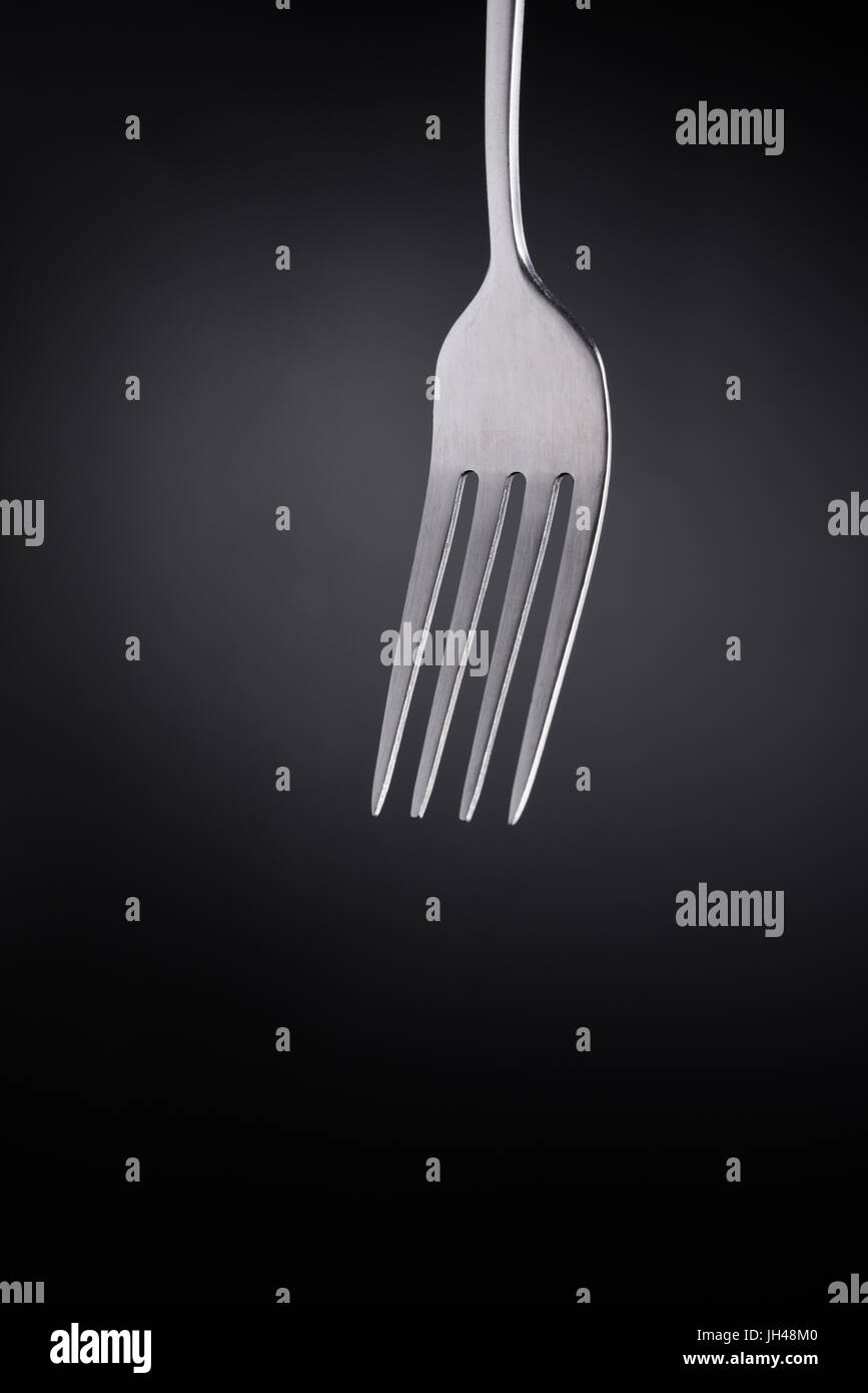 Fork in black background Stock Photo - Alamy