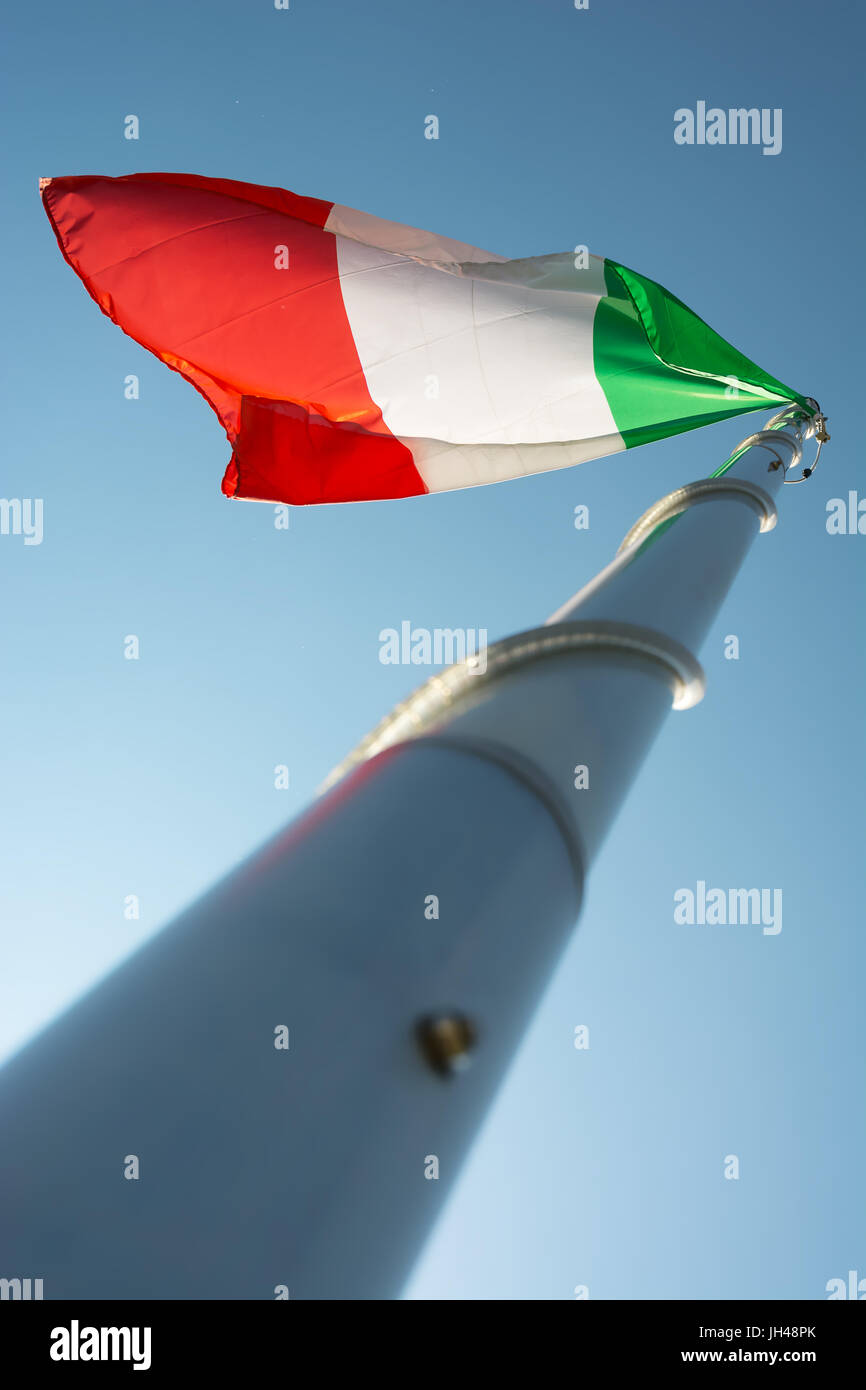 The Italian flag in blue sky Stock Photo - Alamy
