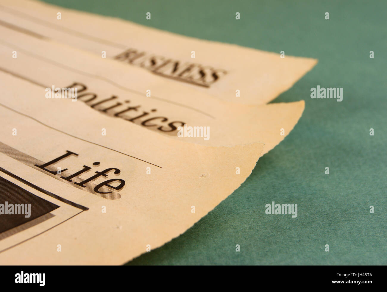 old newspaper on a green background Stock Photo - Alamy
