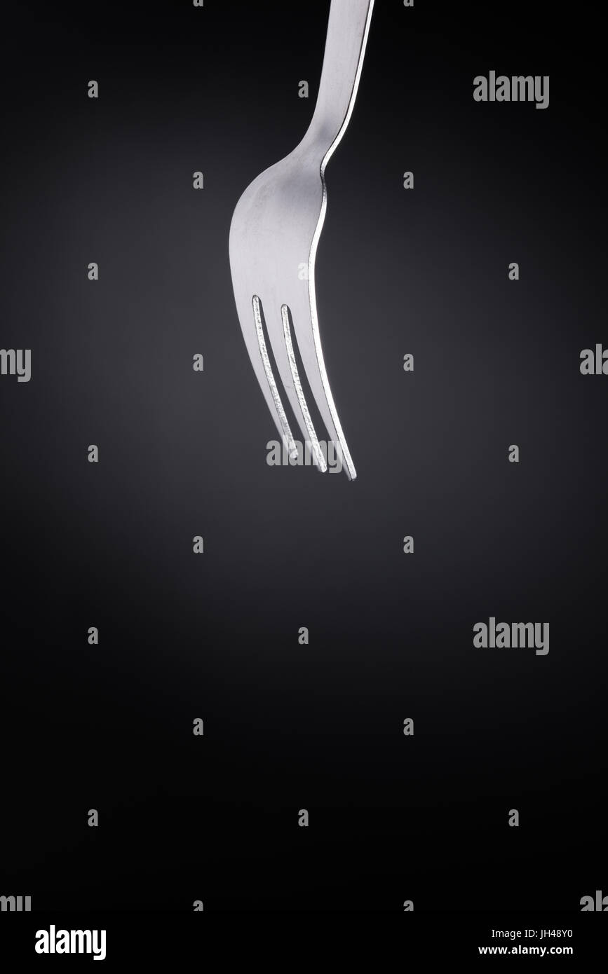Fork in black background Stock Photo - Alamy