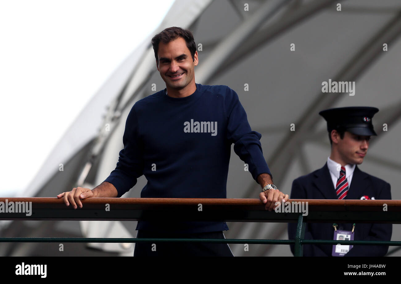 Roger Federer greets spectators from a bridge within the grounds after ...