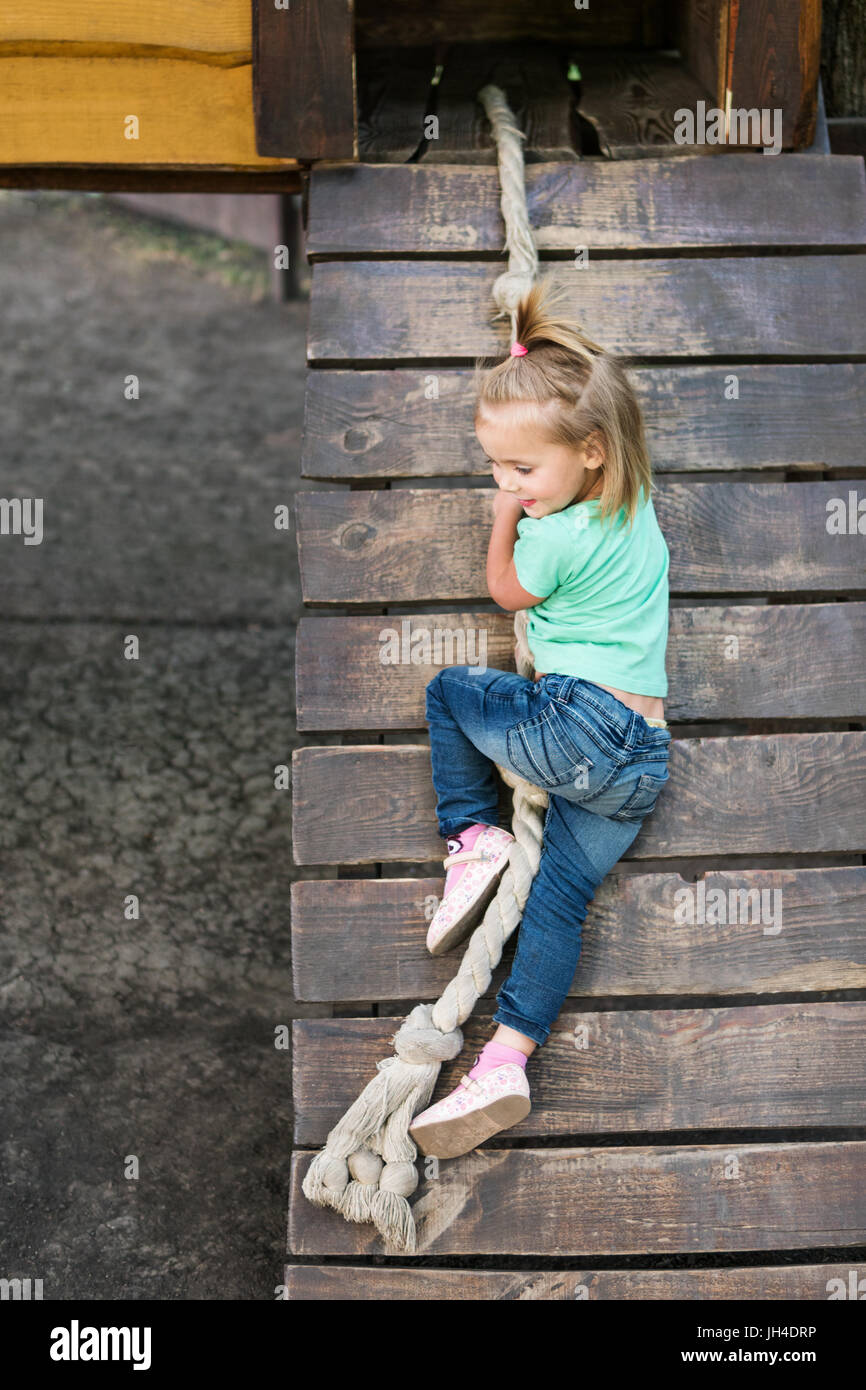 Child climbs the rope Stock Photo - Alamy