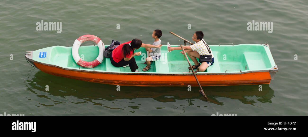 Young family in rowing boat on lake at Summer Palace. Beijing, China ...