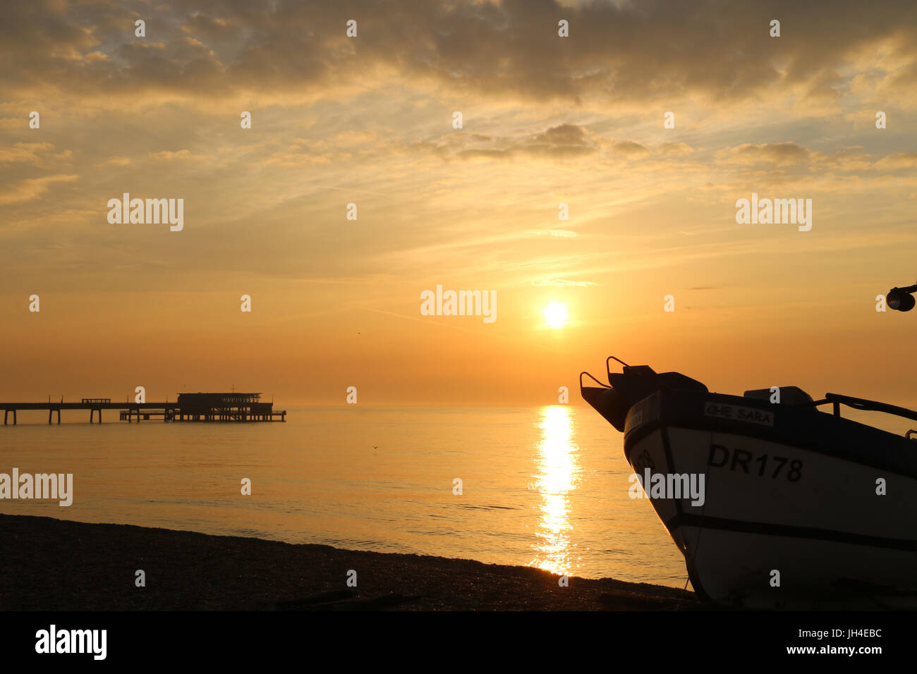 Boat and Pier at sunrise on Walmer Beach Stock Photo - Alamy