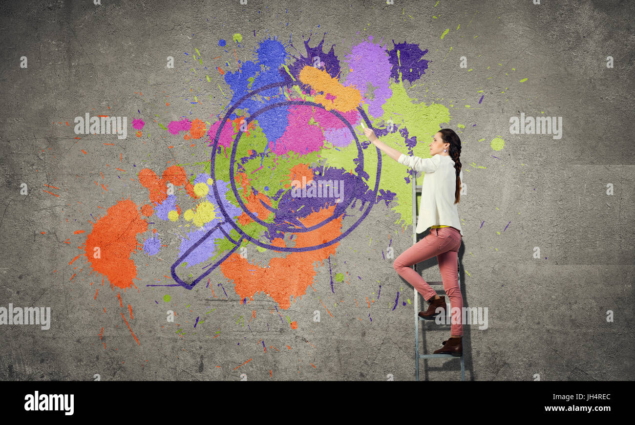 Girl paint wall in colors Stock Photo - Alamy