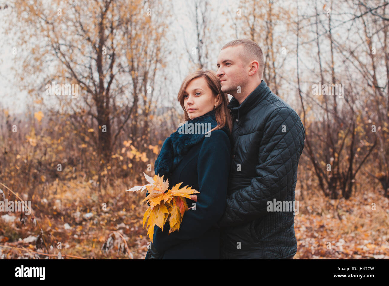 Affectionate cozy hugs of young loving couple in the autumn park Stock ...