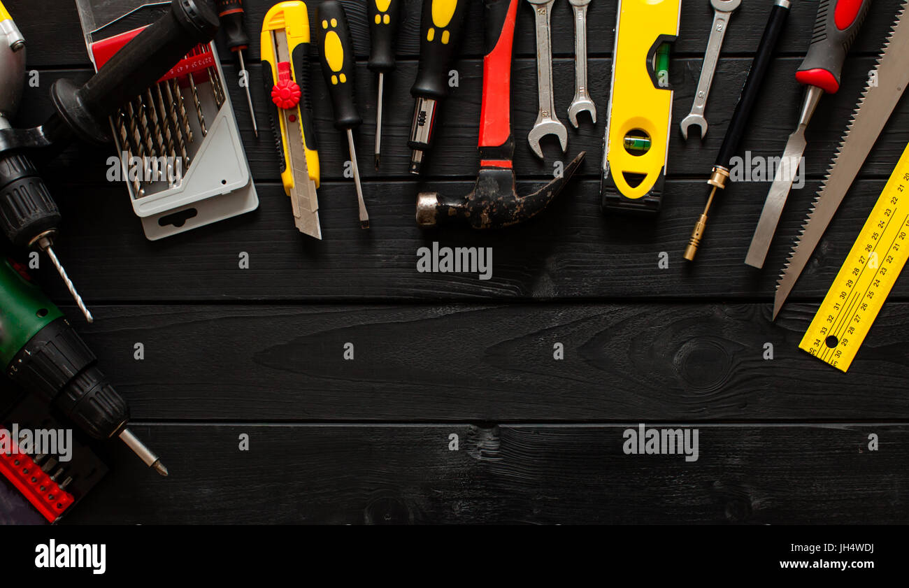 A set of tools laid out in a semicircle on top of the wooden table with ...