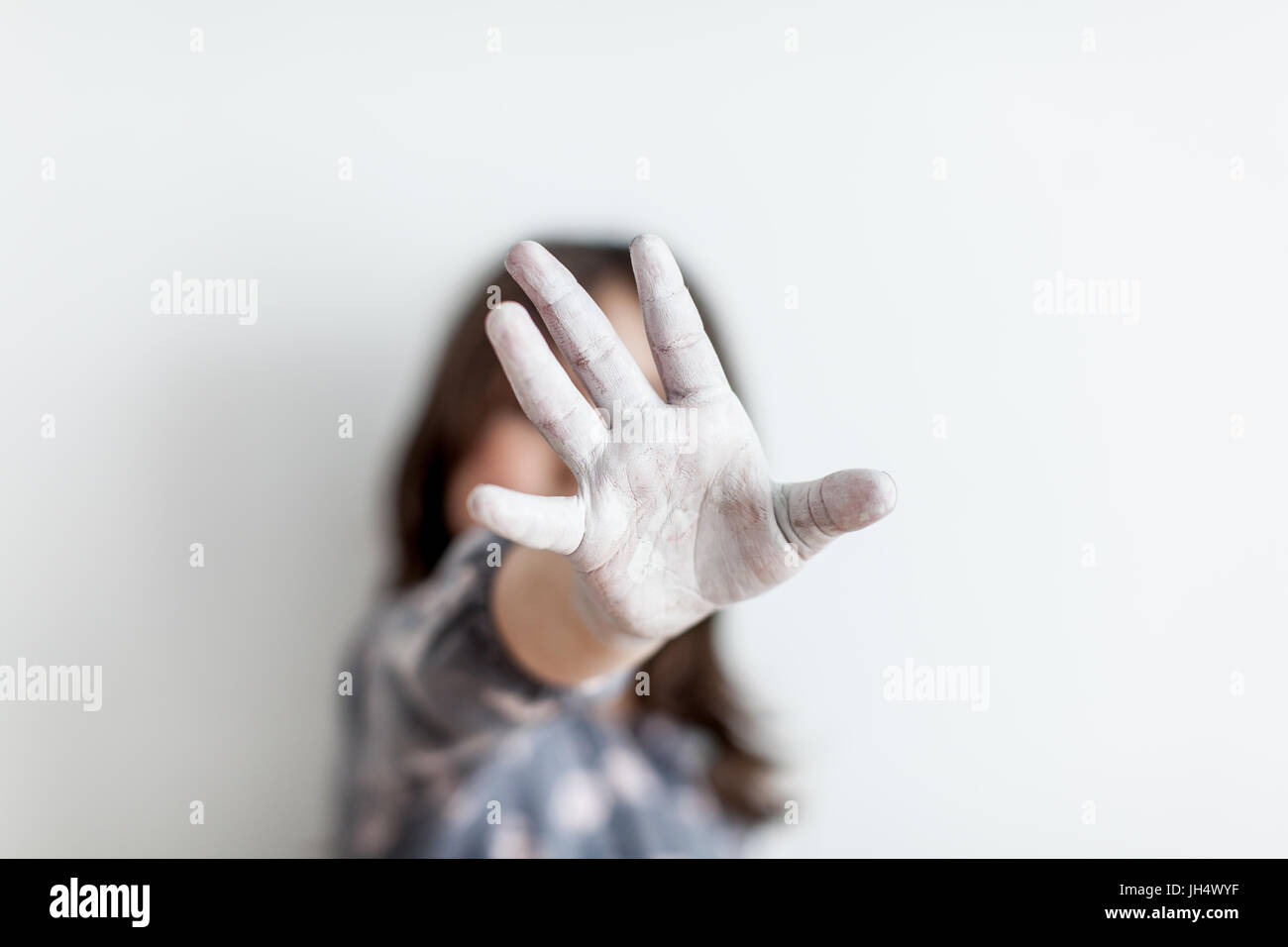 Silhouette young girl with her hand extended signaling to stop. Concept ...