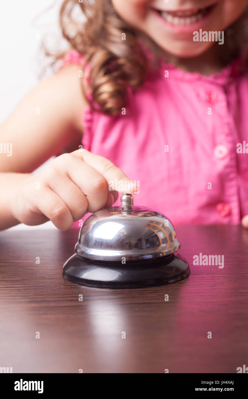 Little pretty girl push on the bell, board game on time Stock Photo - Alamy