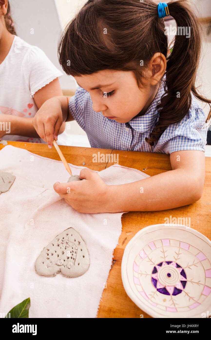 Process modeling figures from plasticine. Children are sitting on the ...
