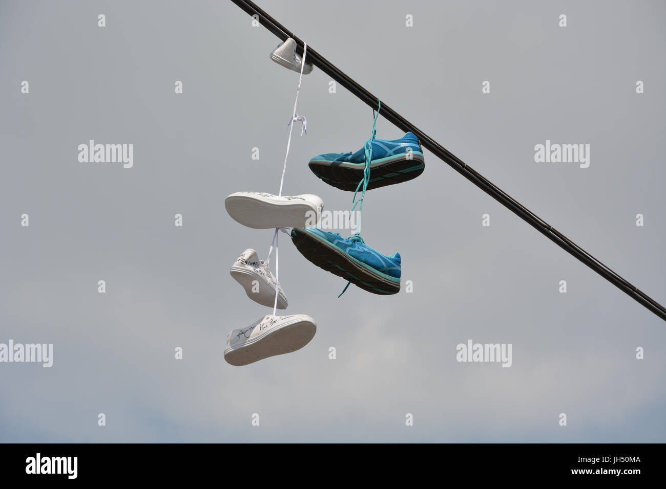 Sneakers hanging telephone wire hi-res stock photography and images - Alamy