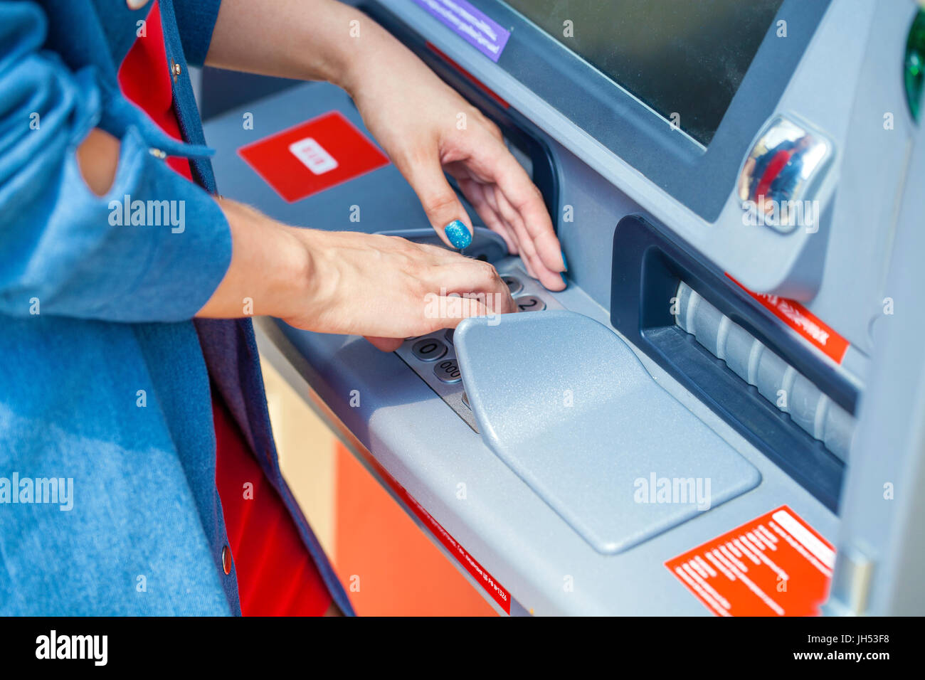 Female arms, ATM - entering pin Stock Photo - Alamy