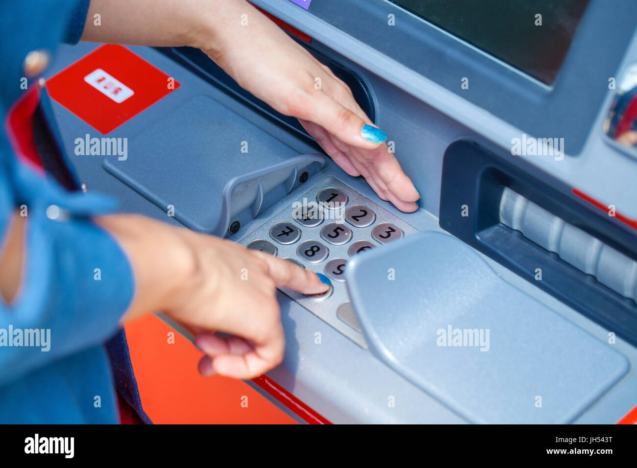 Female arms, ATM - entering pin Stock Photo - Alamy
