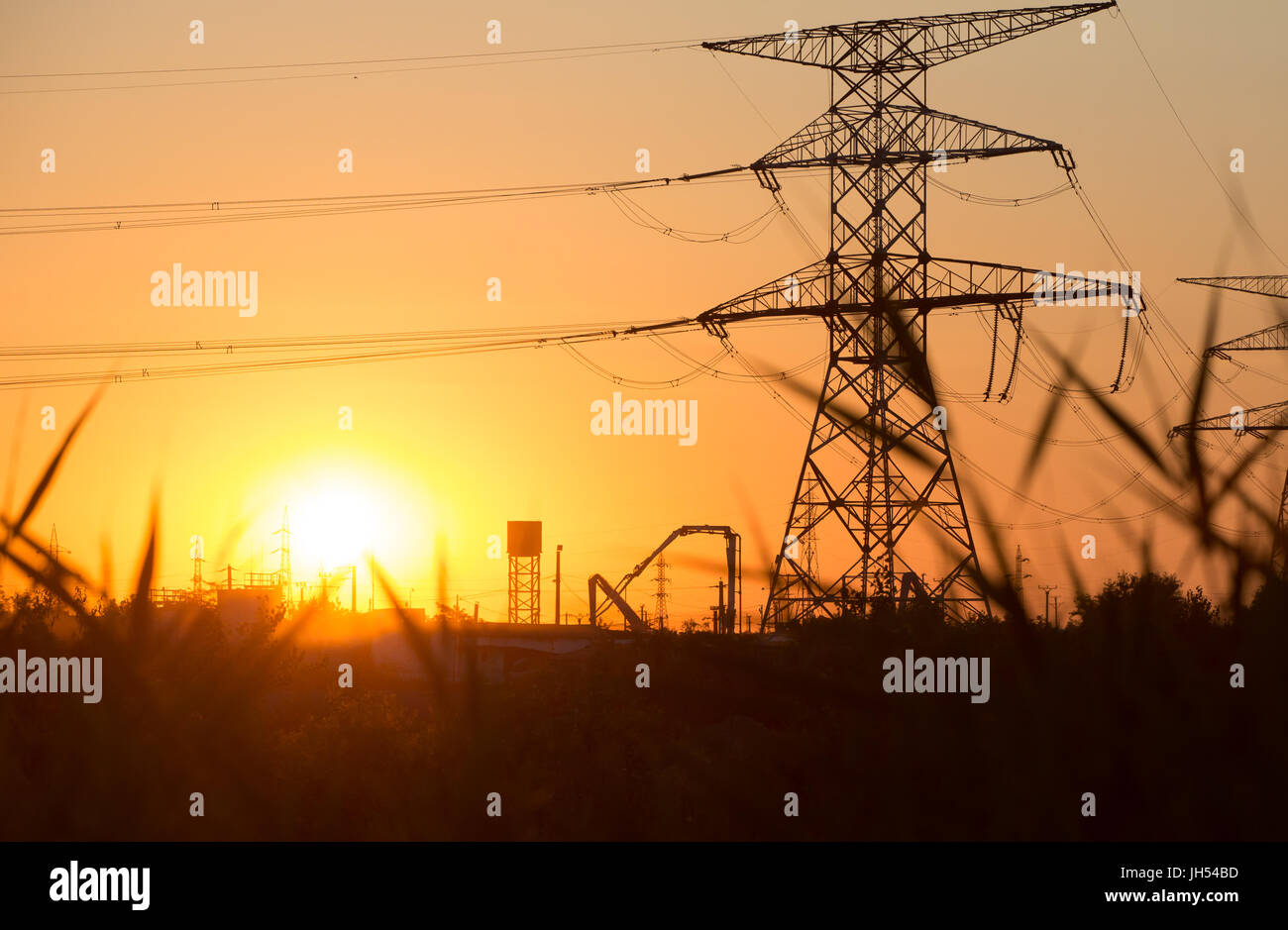 High voltage transmission power line silhouette on sunset Stock Photo ...