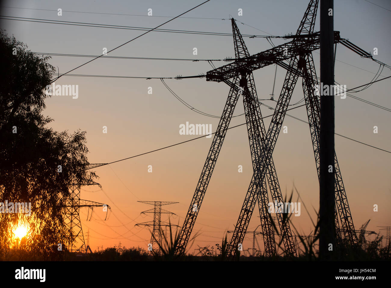 High voltage transmission power line silhouette on sunset Stock Photo ...