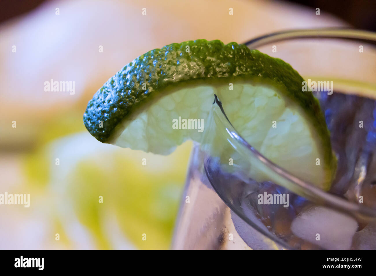 A slice of lime garnish on ice water Stock Photo - Alamy
