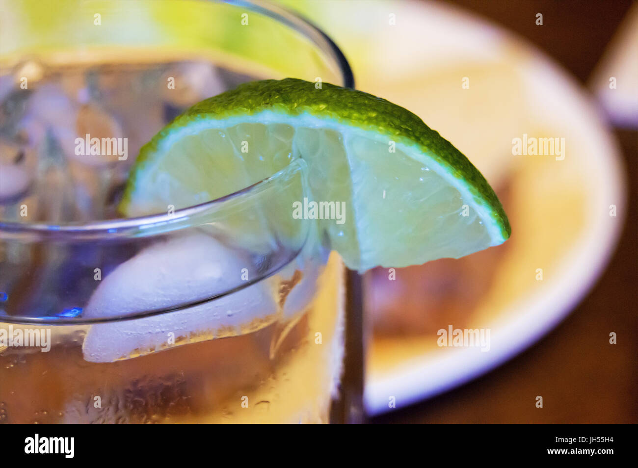 A slice of lime garnish on ice water Stock Photo - Alamy