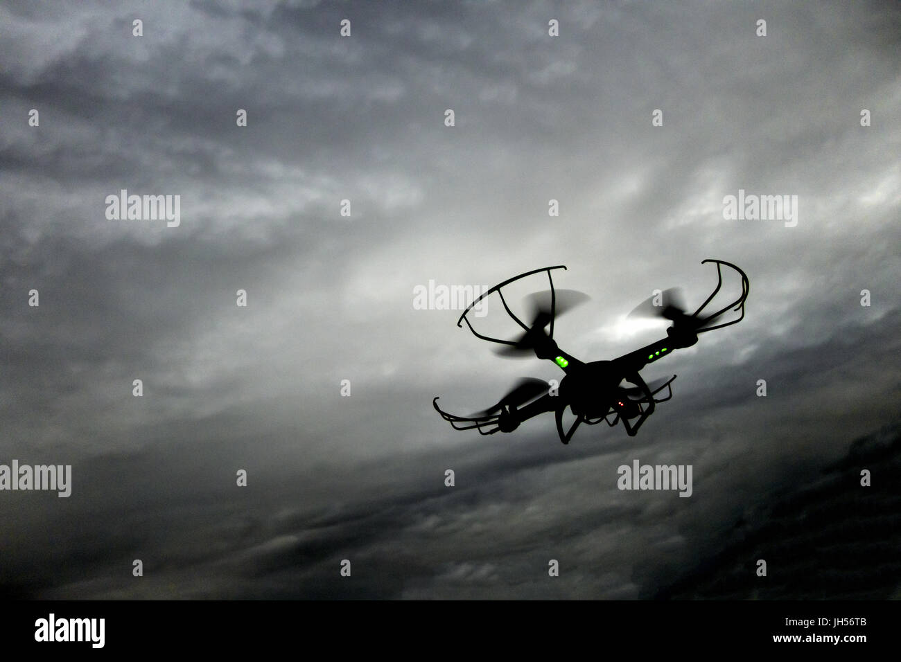 A drone flying in dark clouds with red and green lights. Concept of ...