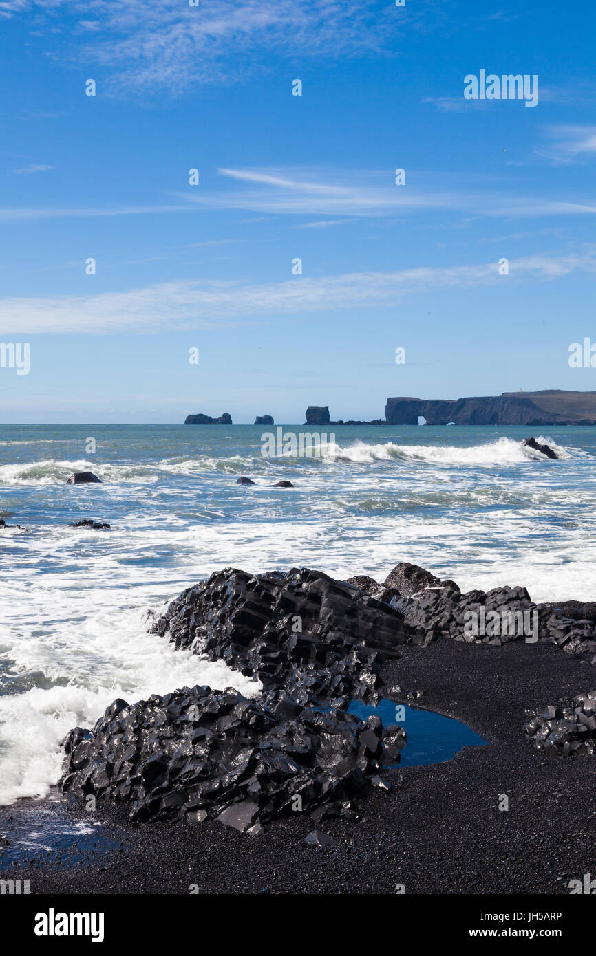View of basalt sea stacks from the black sand beach at Reynisfjara in ...